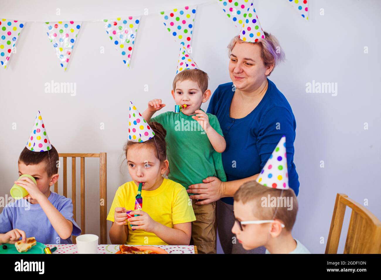 Cheerful kids and young woman at Birthday party Stock Photo - Alamy