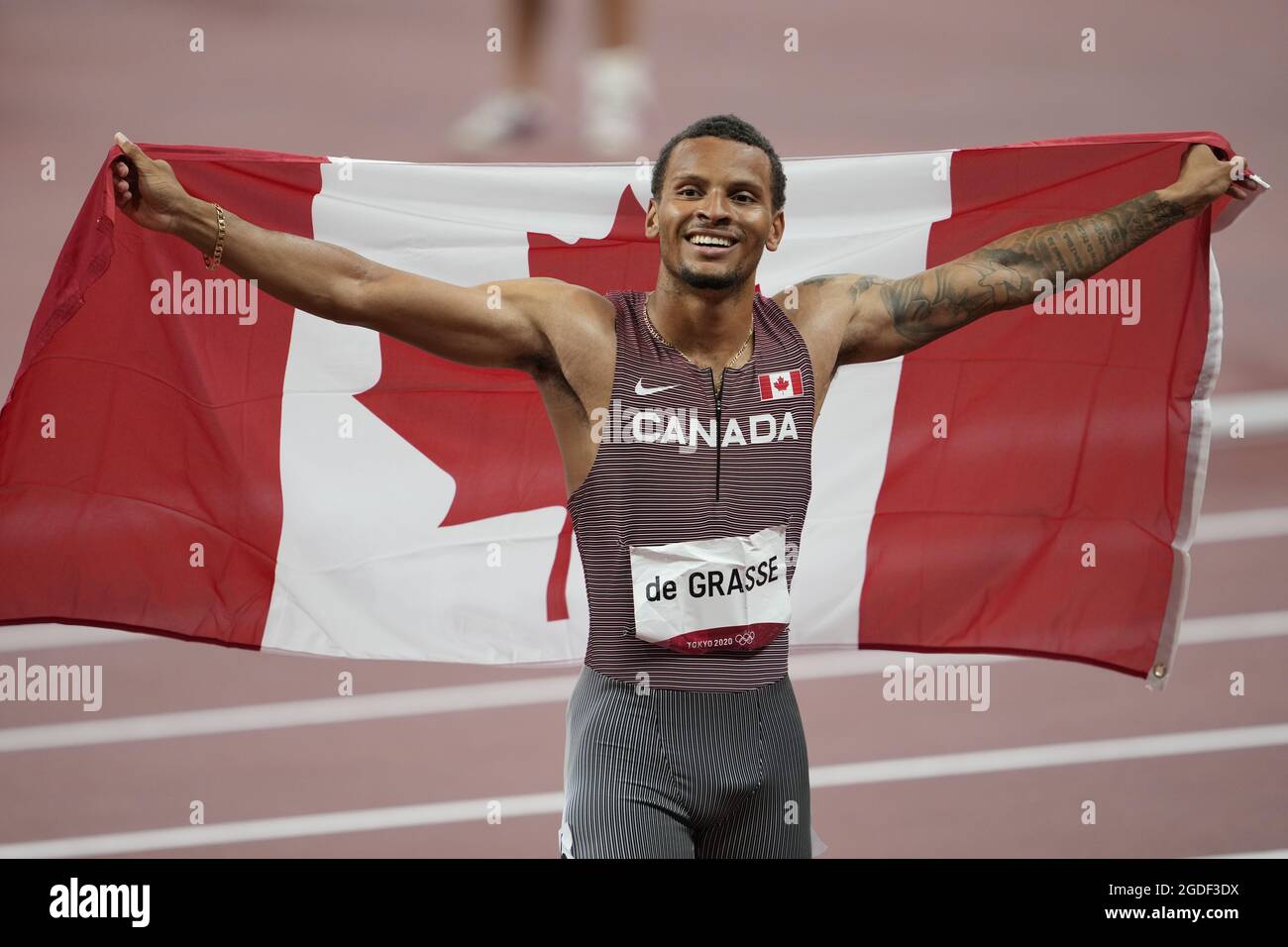 Andre De Grasse with the Canadian flag after being proclaimed Olympic ...