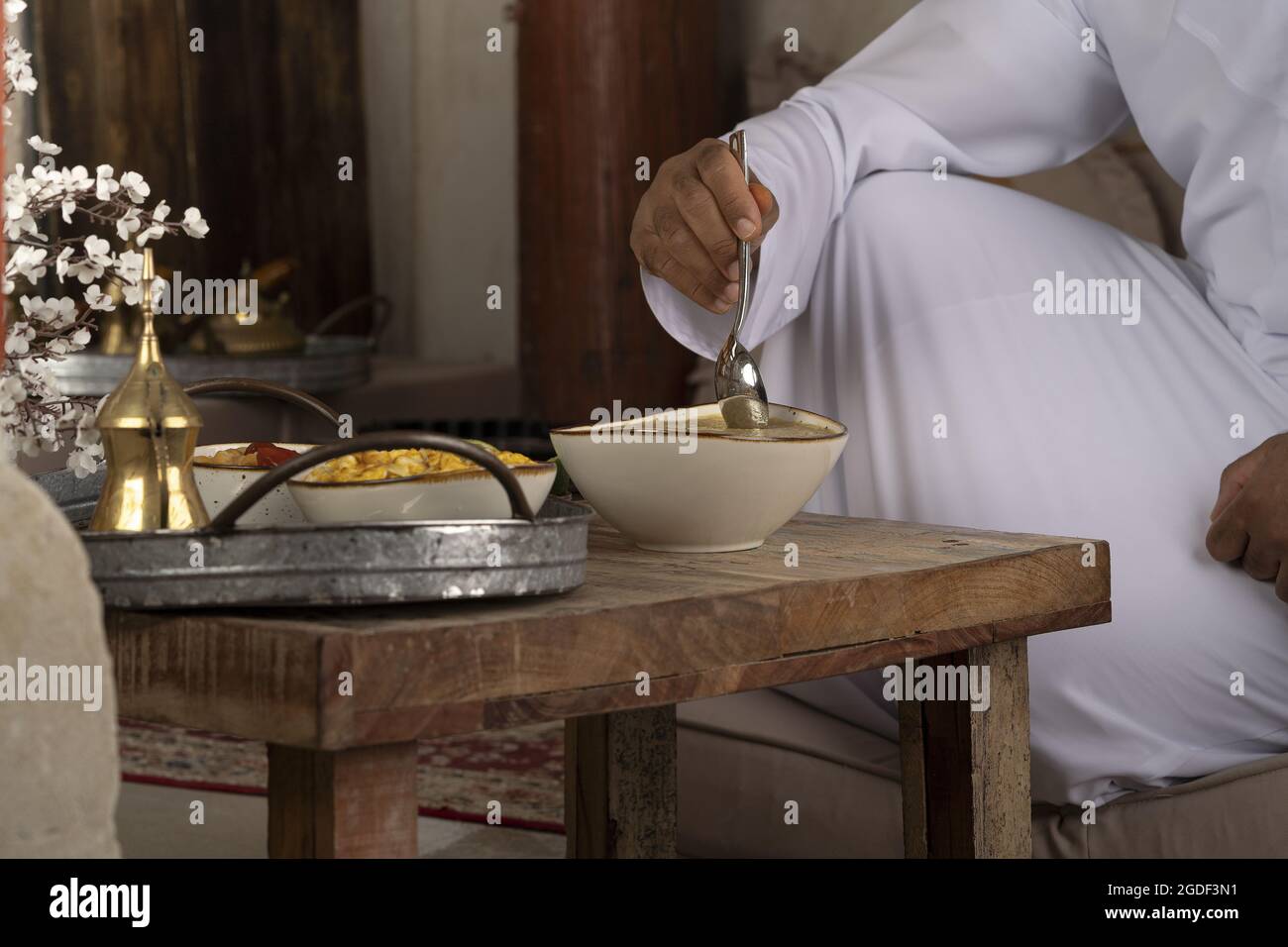 Man eating emirates traditional food at the table Stock Photo - Alamy