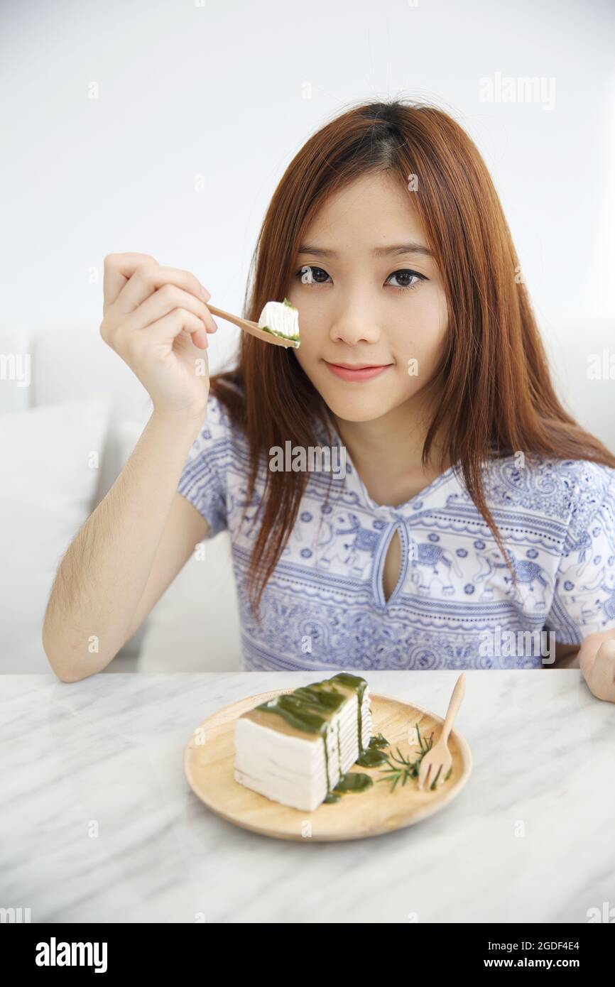 Young asian woman eating hi-res stock photography and images - Alamy