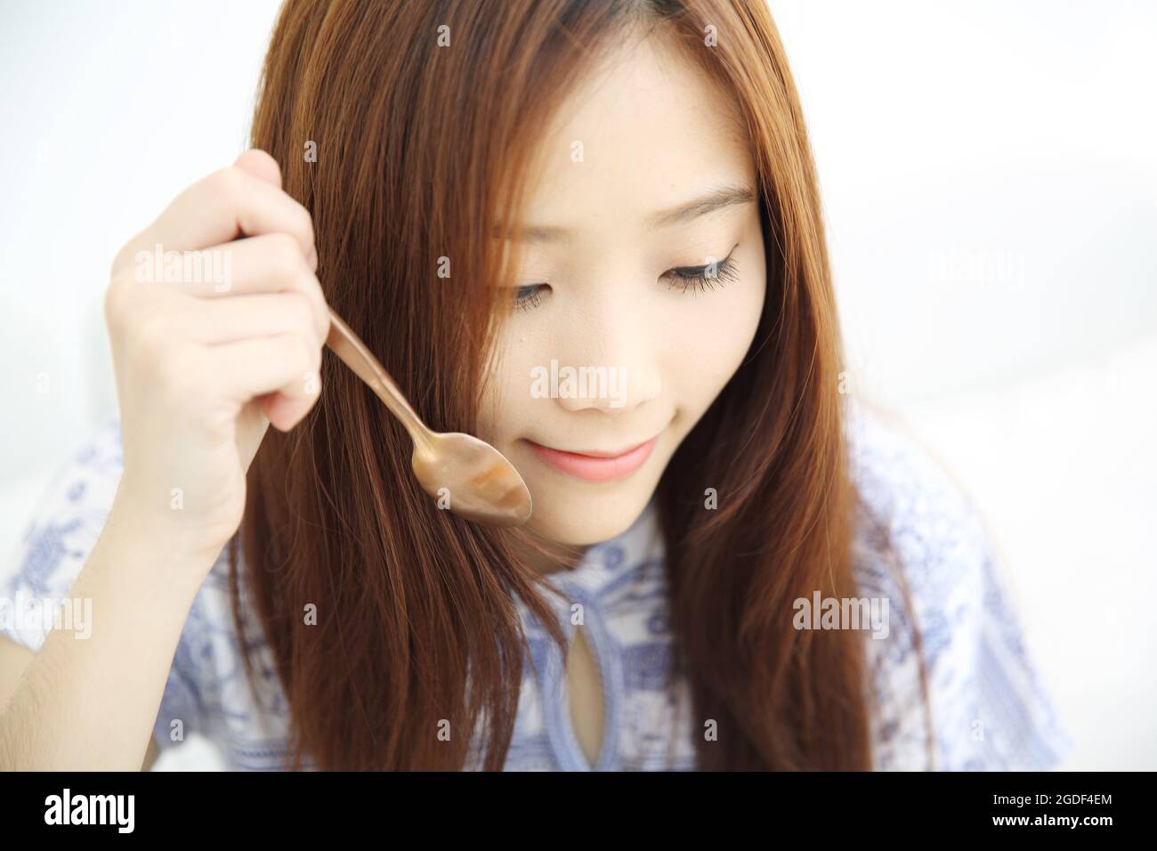 Asian young woman eating Shaved ice with milk and coconut Stock Photo ...
