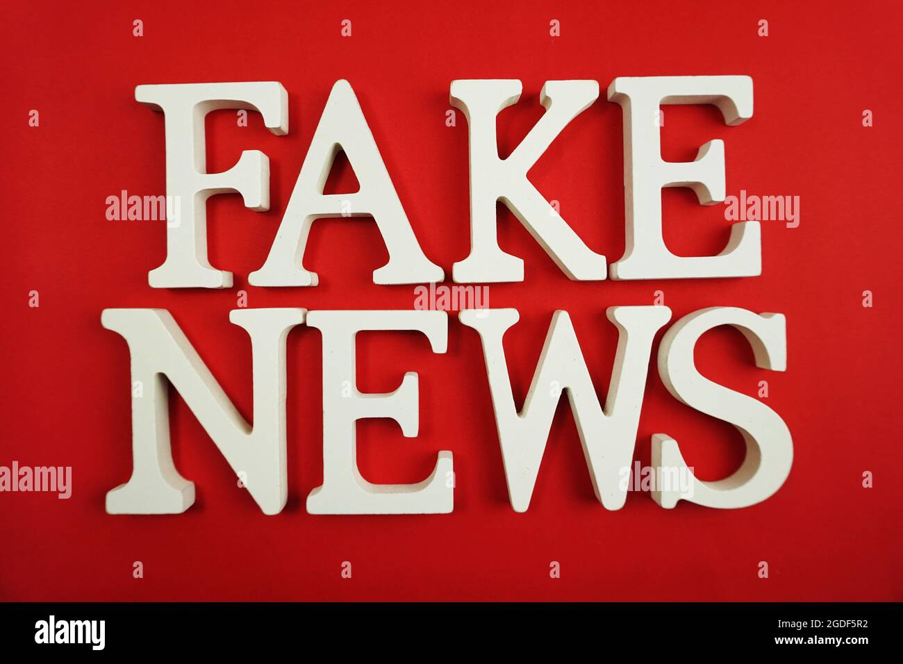 Fake News alphabet letters on red background Stock Photo - Alamy