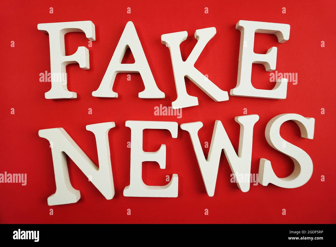 Fake News alphabet letters on red background Stock Photo - Alamy