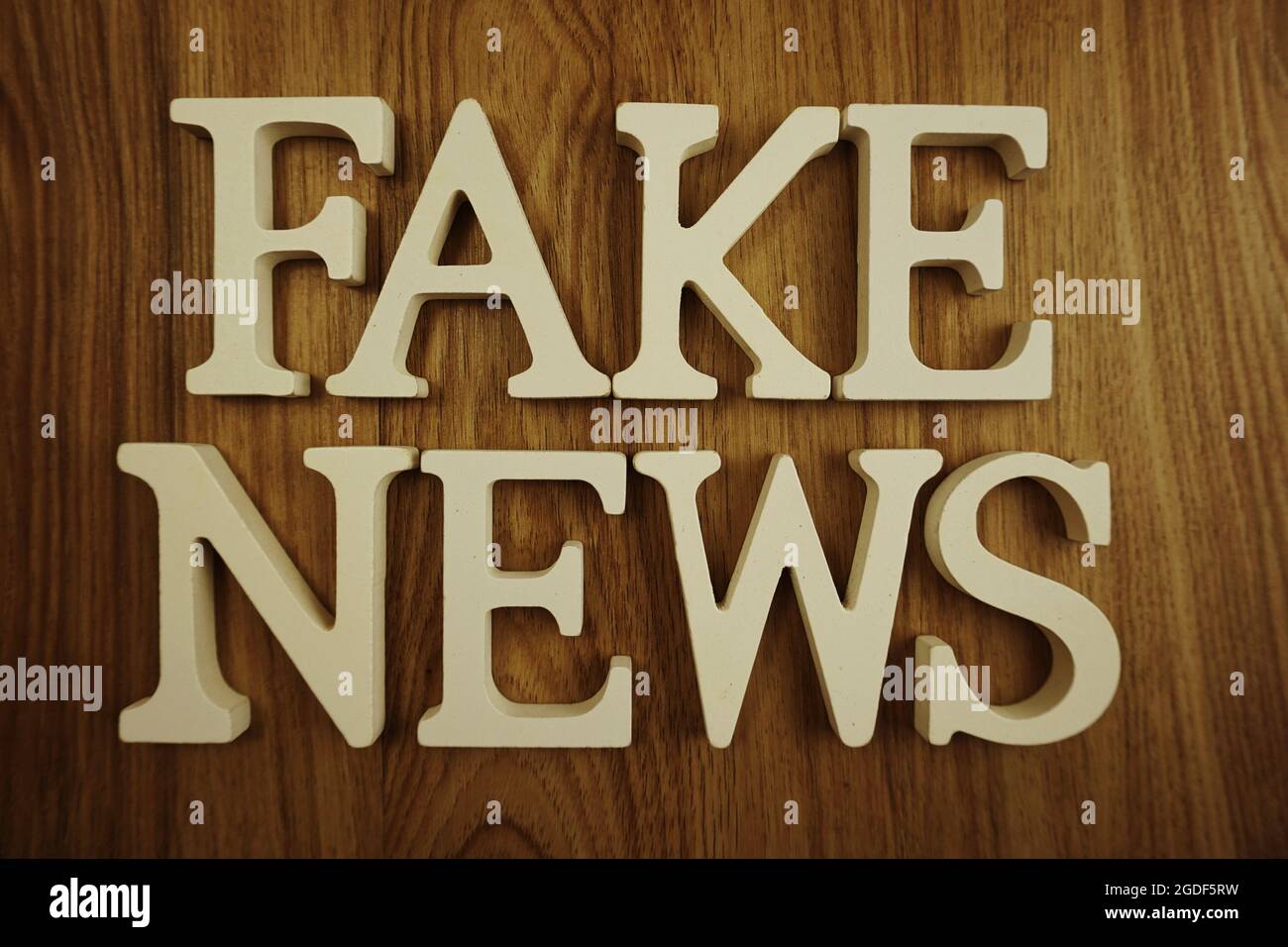 Fake News alphabet letters on wooden background Stock Photo - Alamy