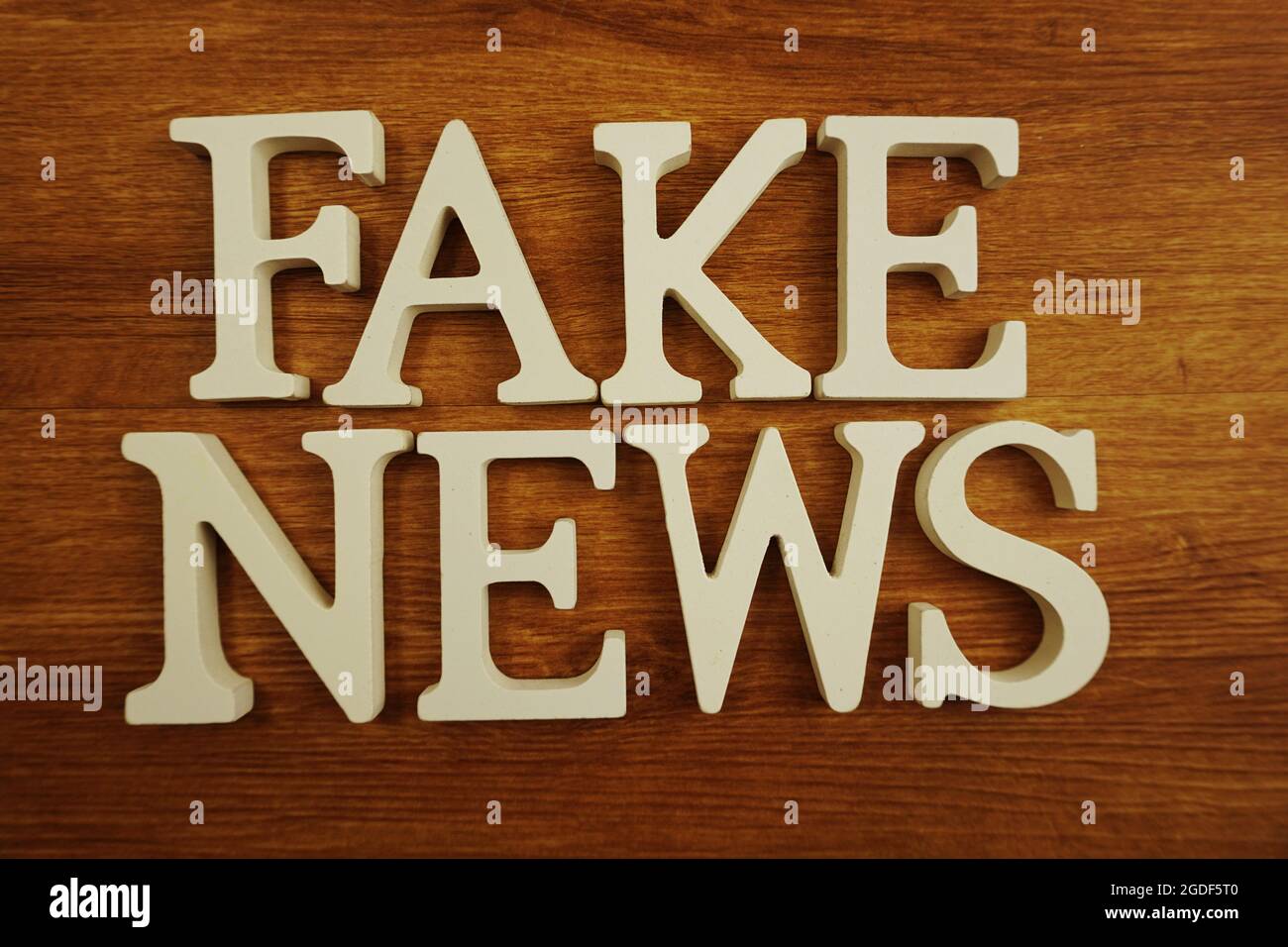 Fake News alphabet letters on wooden background Stock Photo - Alamy