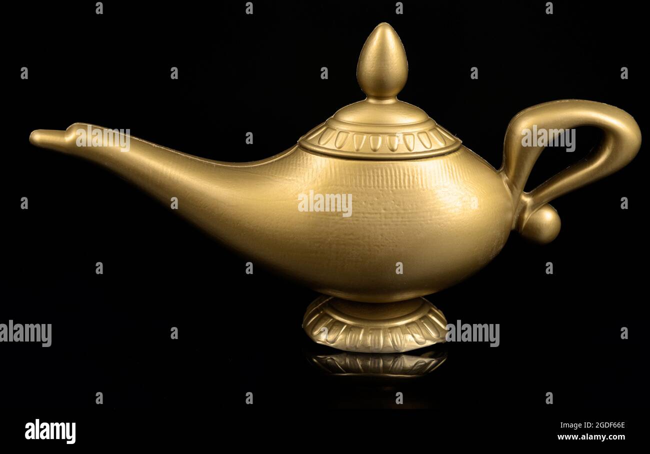 Magic lamp isolated on black Stock Photo - Alamy
