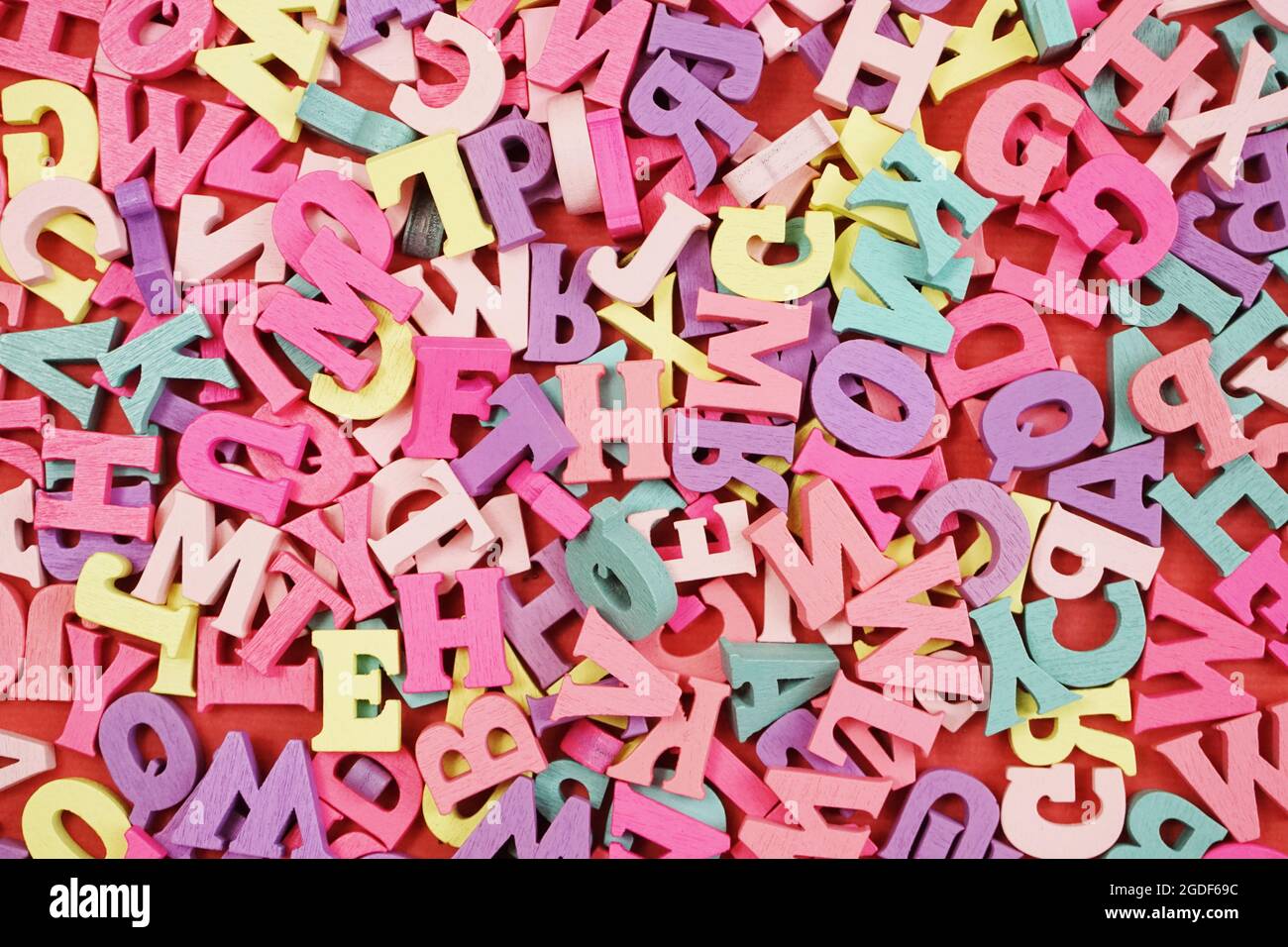 random colorful letterpress alphabet top view on red background Stock ...