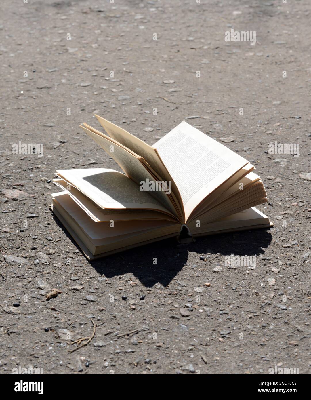 Open book on road outdoors Stock Photo - Alamy