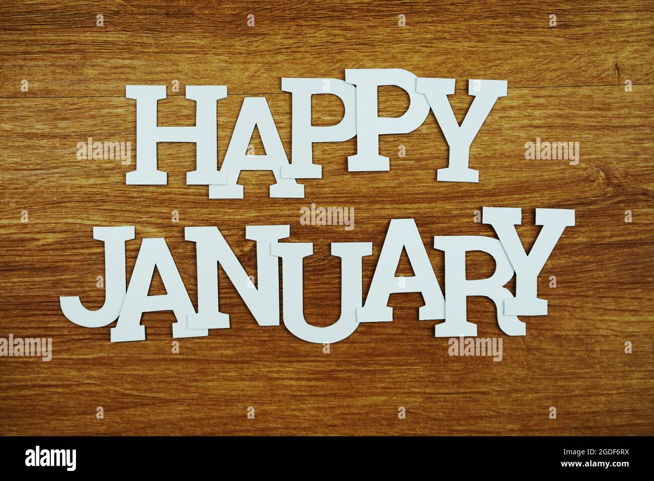 Happy January alphabet letters on wooden background Stock Photo - Alamy