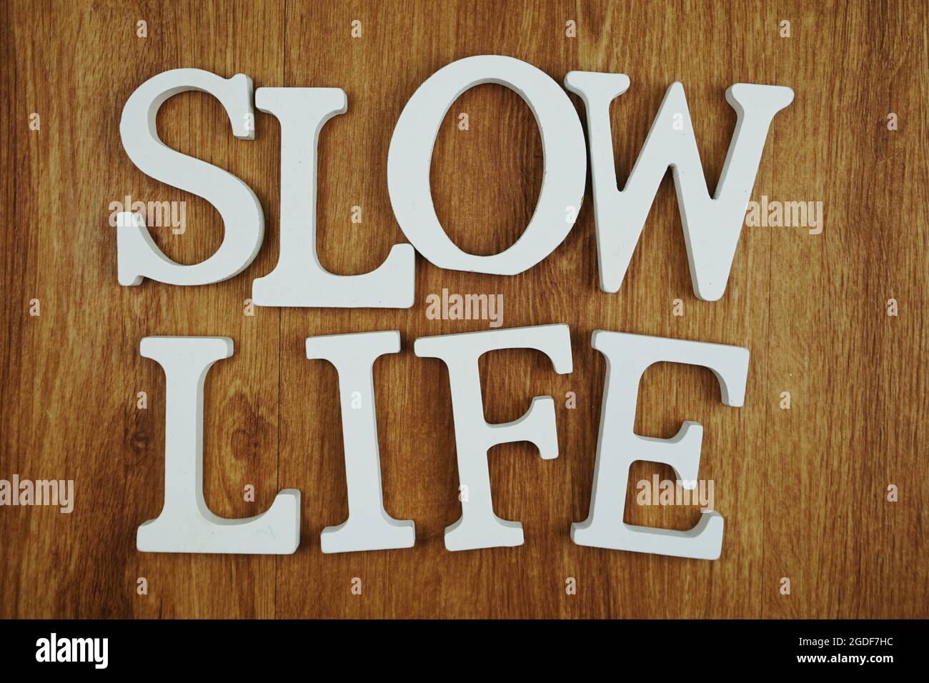Slow Live alphabet letters on wooden background Stock Photo - Alamy