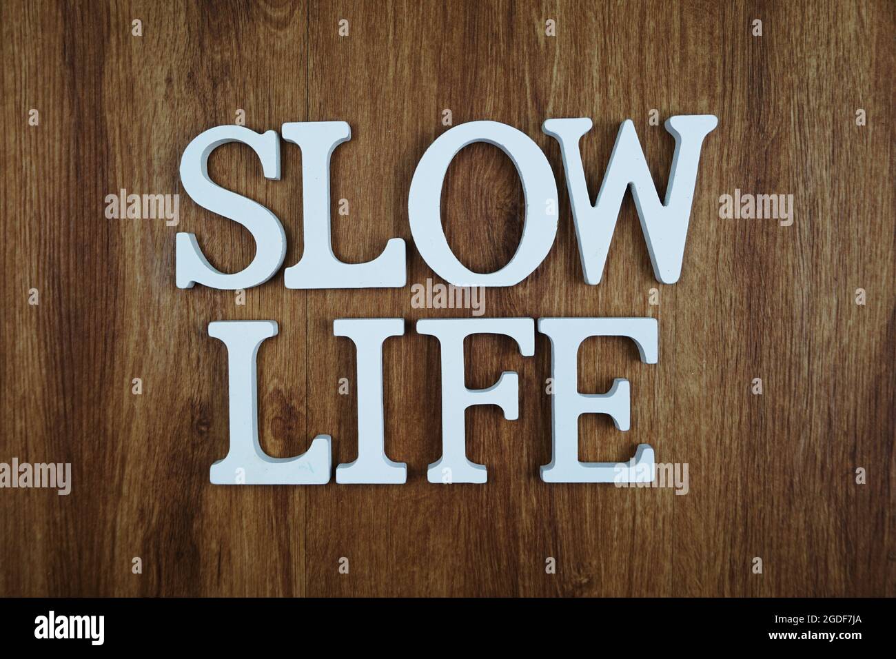Slow life alphabet letters on wooden background Stock Photo - Alamy
