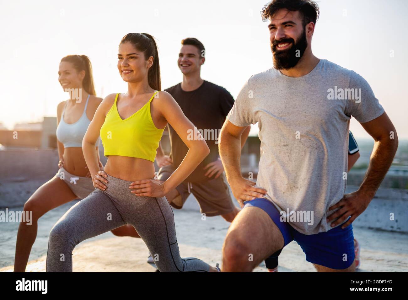 Group of happy fit people friends exercising together outdoor Stock ...