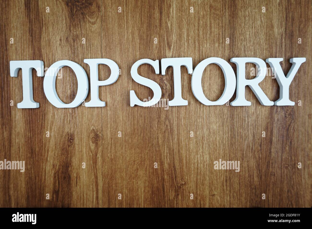 Top Story alphabet letters on wooden background Stock Photo - Alamy