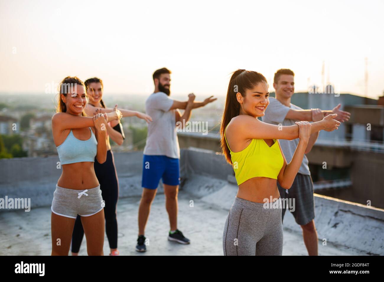 Group of fit healthy friend, people exercising together outdoor Stock ...