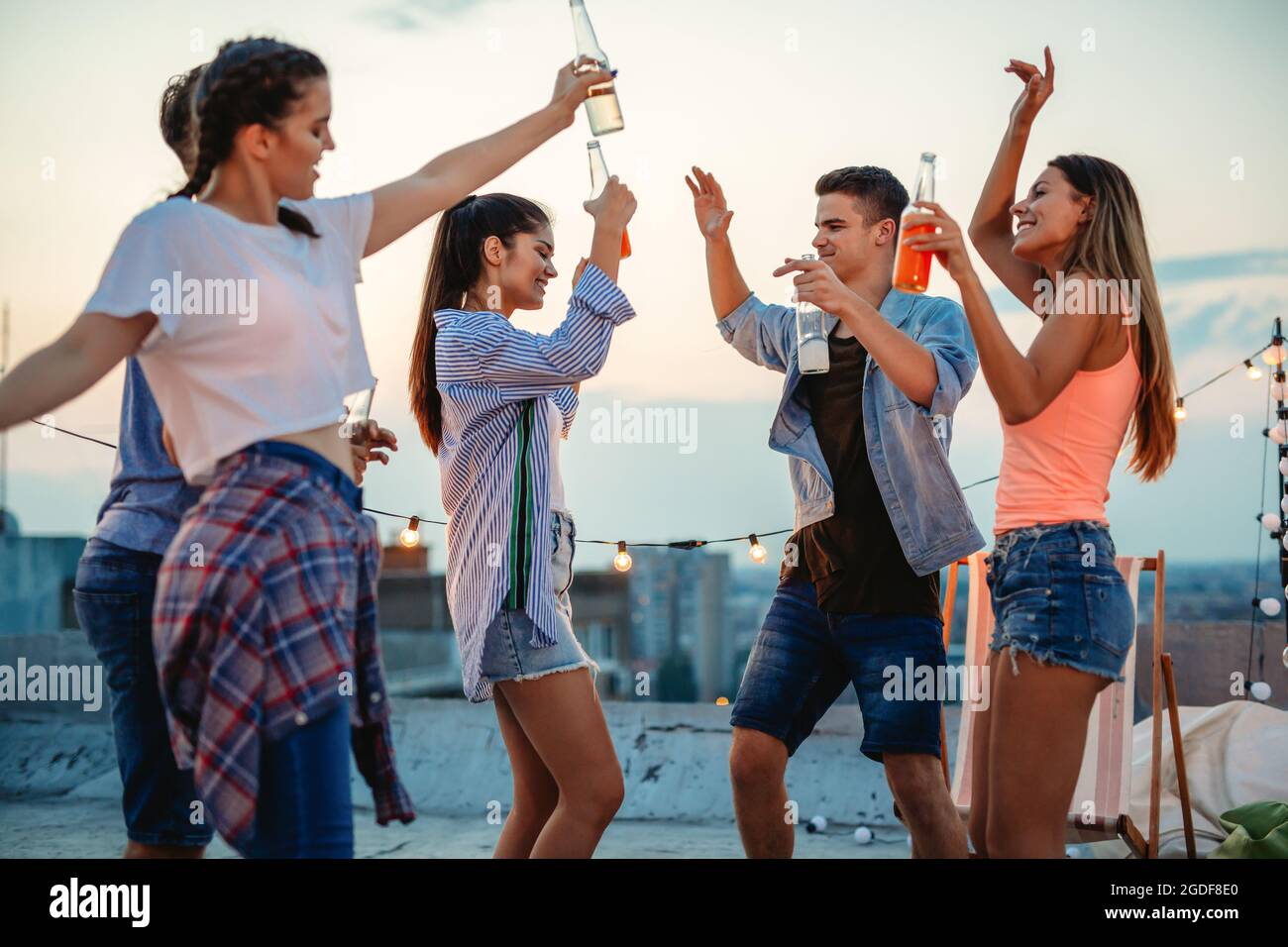 Group of happy friends having fun at rooftop party Stock Photo - Alamy