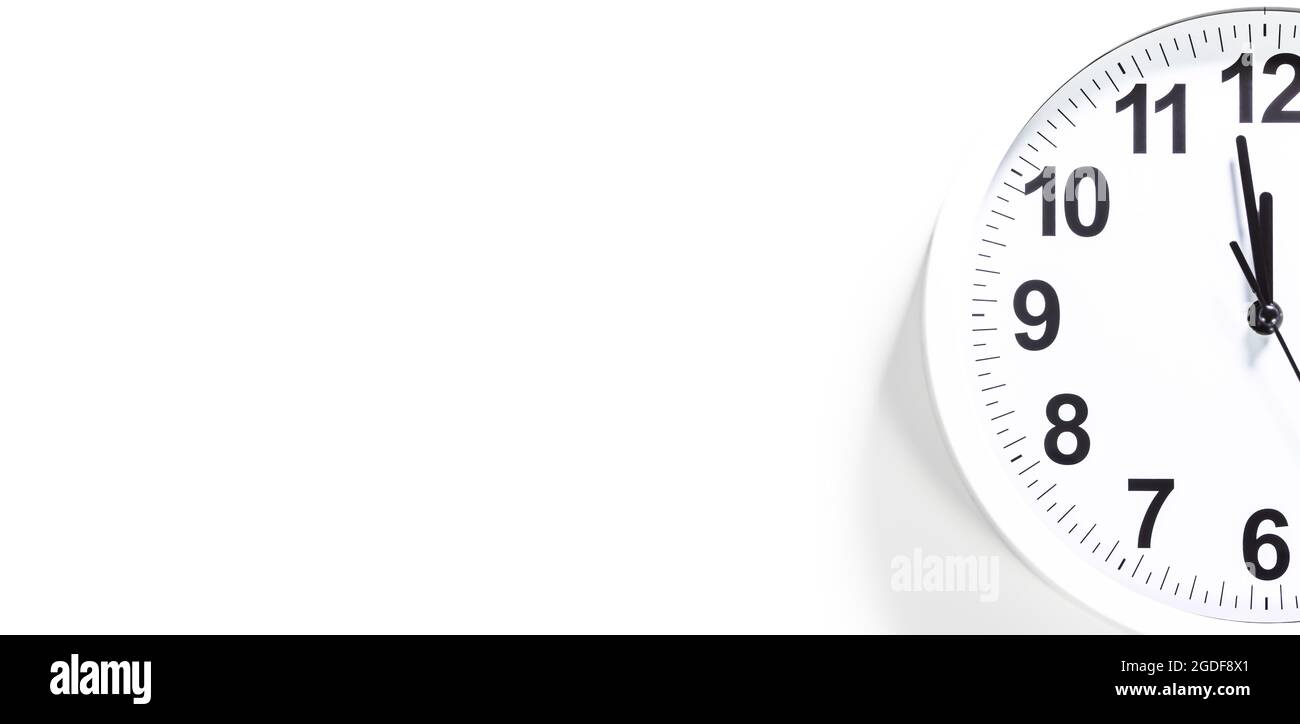 White clock face of wall clock show the time. It's close to 12 o'clock ...