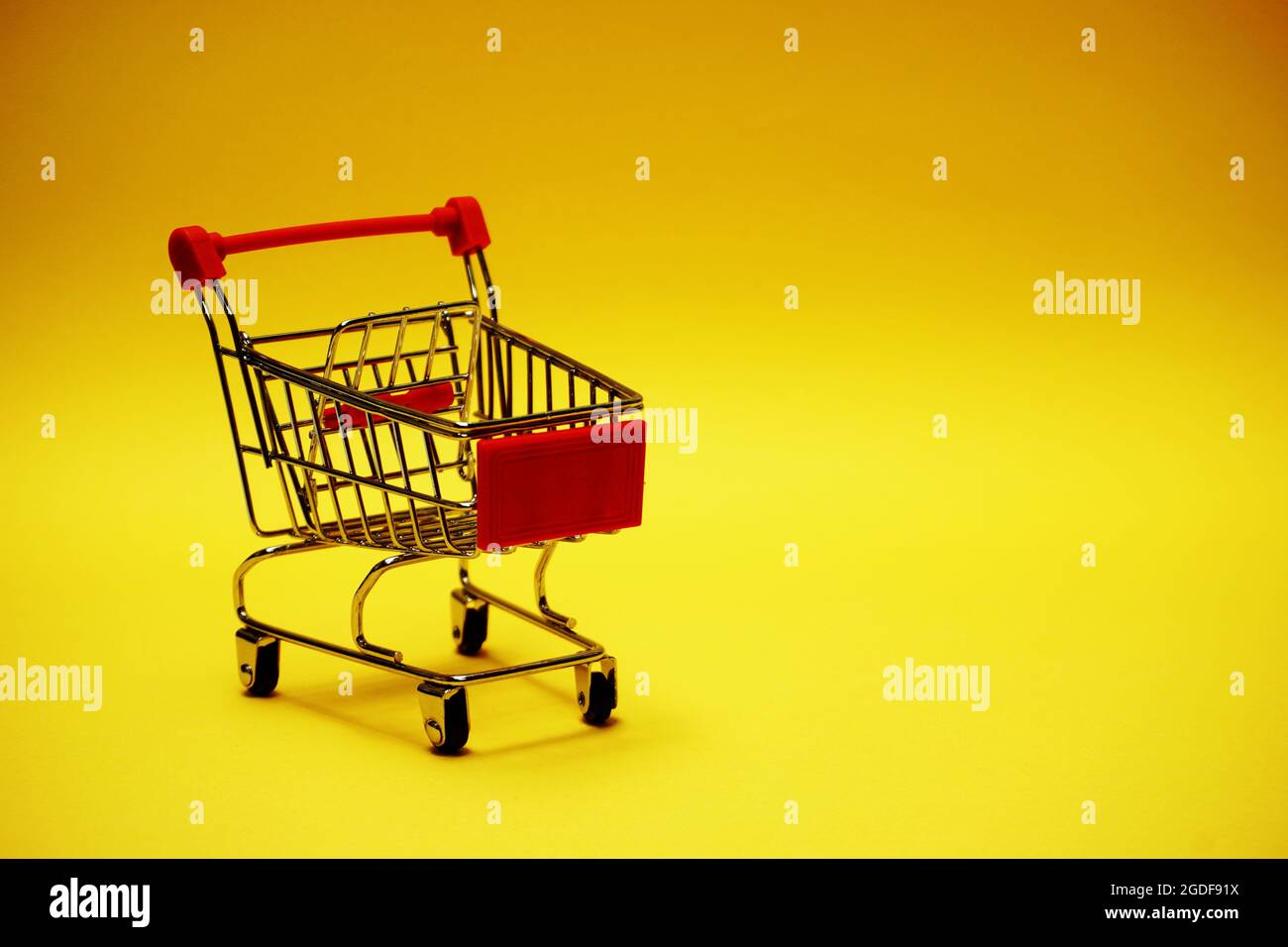 Mini trolley cart on yellow background Stock Photo - Alamy