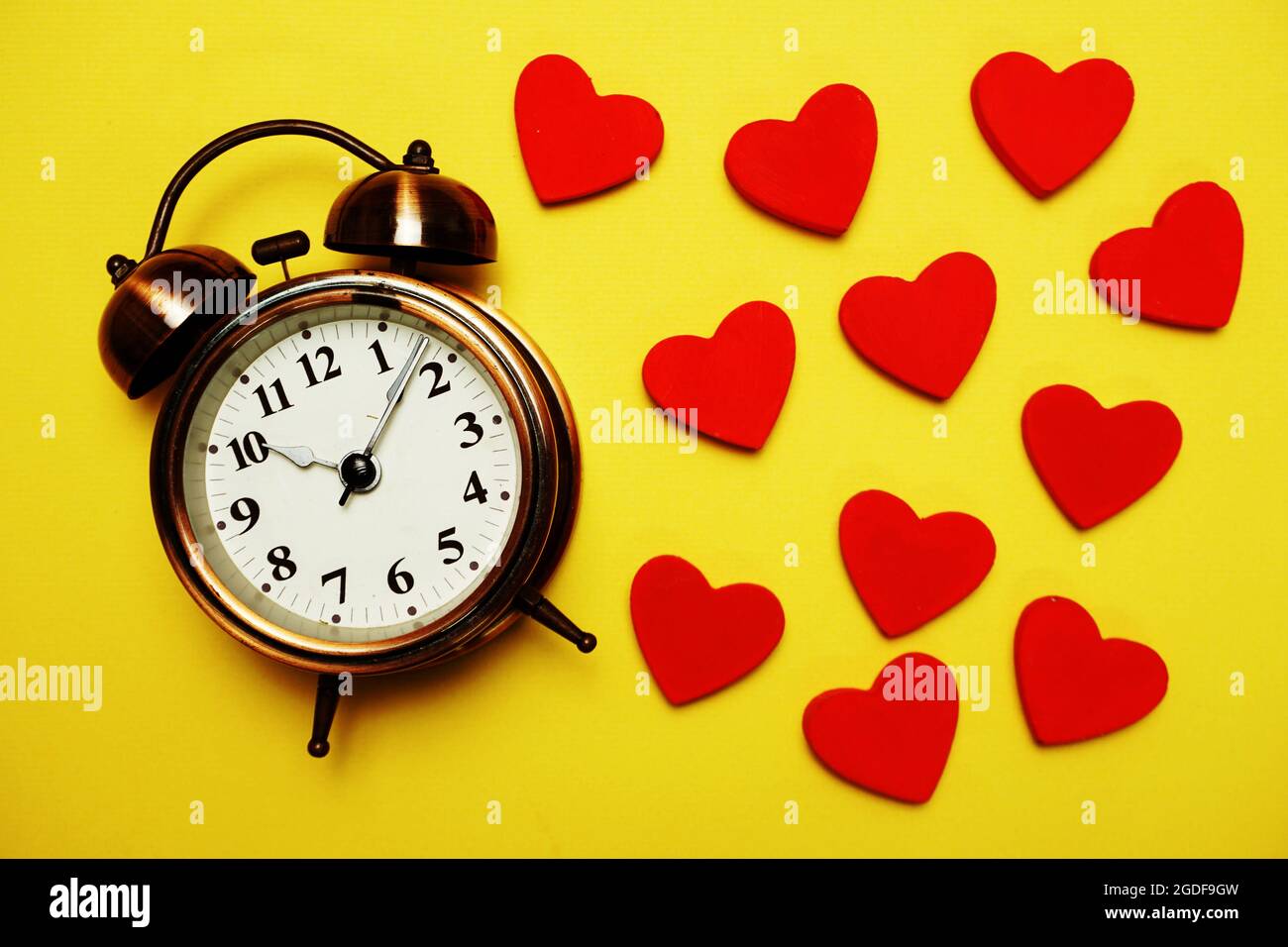 Vintage Alarm clock with red heart Stock Photo - Alamy