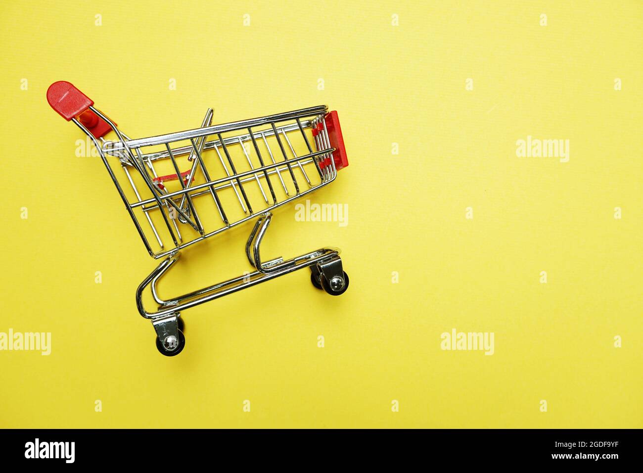 Mini trolley cart with space copy on yellow background Stock Photo - Alamy