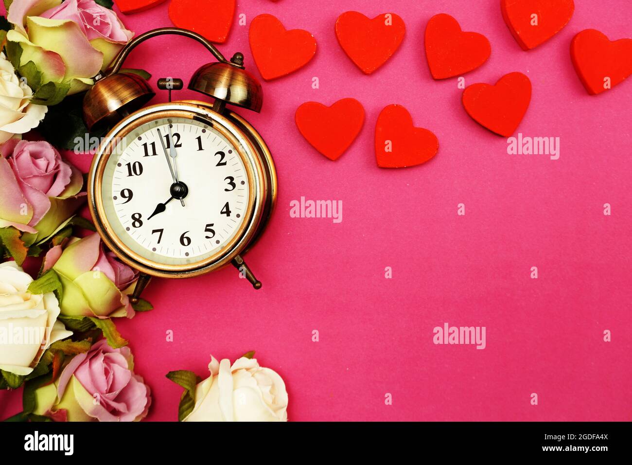 Rose flowers bouquet and vintage alarm clock with space copy on Pink ...