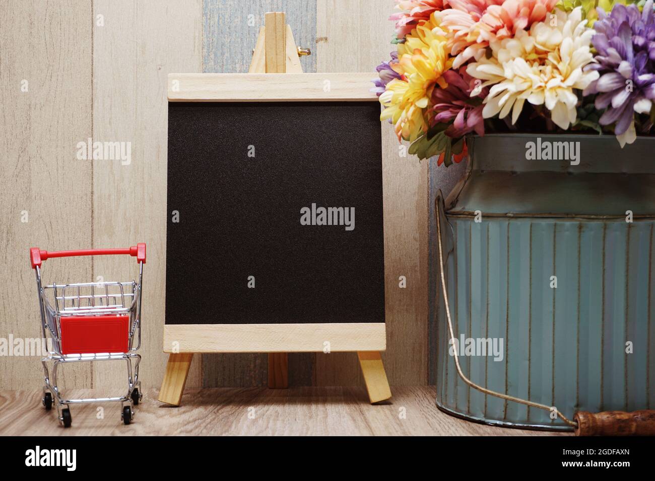 Mini trolley cart and Space wooden easel blackboard Stock Photo - Alamy
