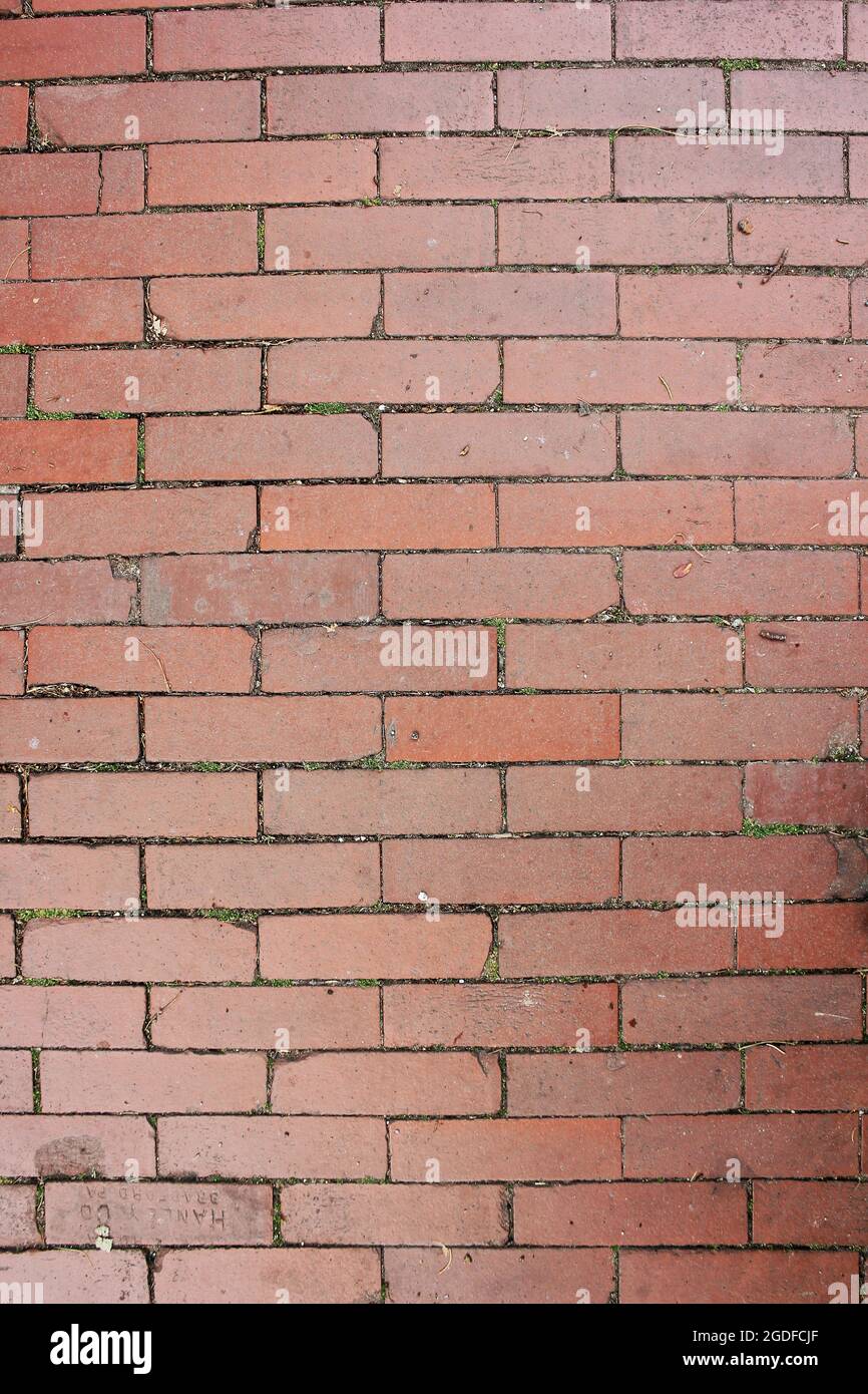 Hardy and rugged masonry brick wall created from many colorful bricks ...