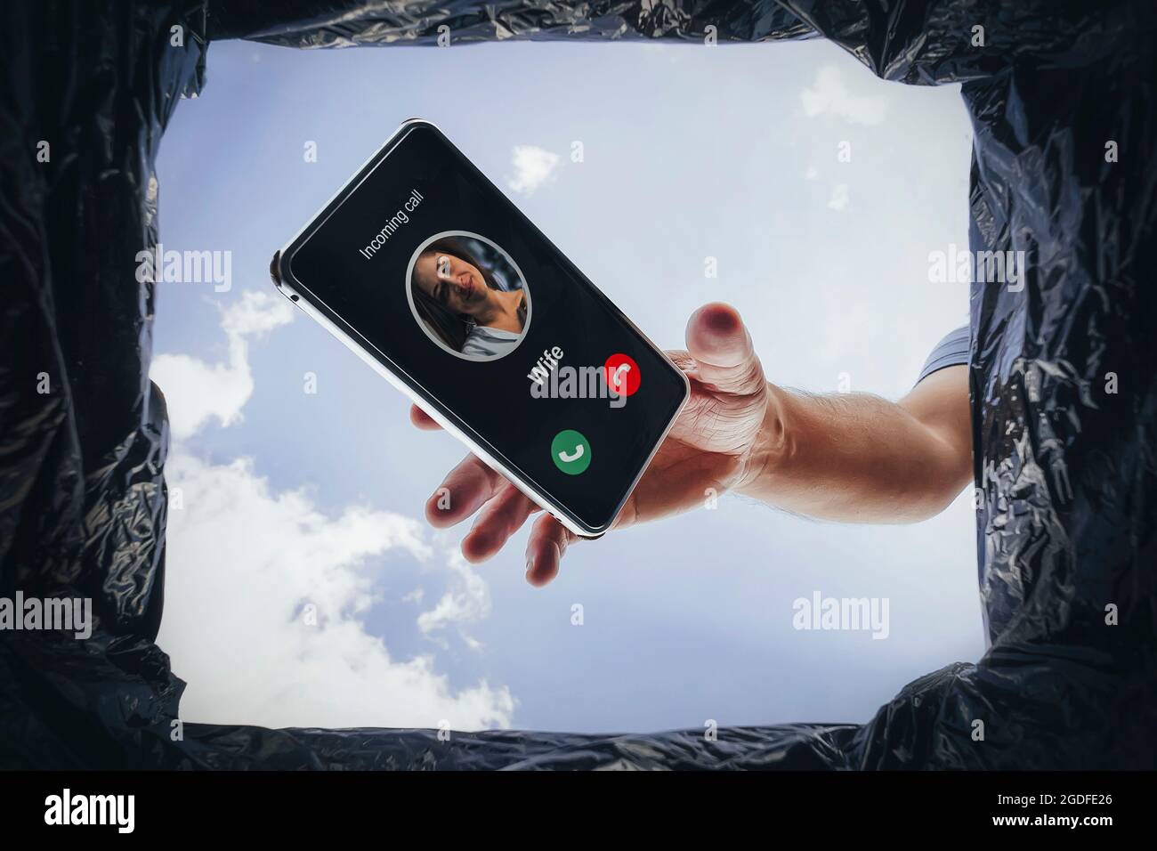 male hand holding smart phone with incoming call from wife and throwing ...