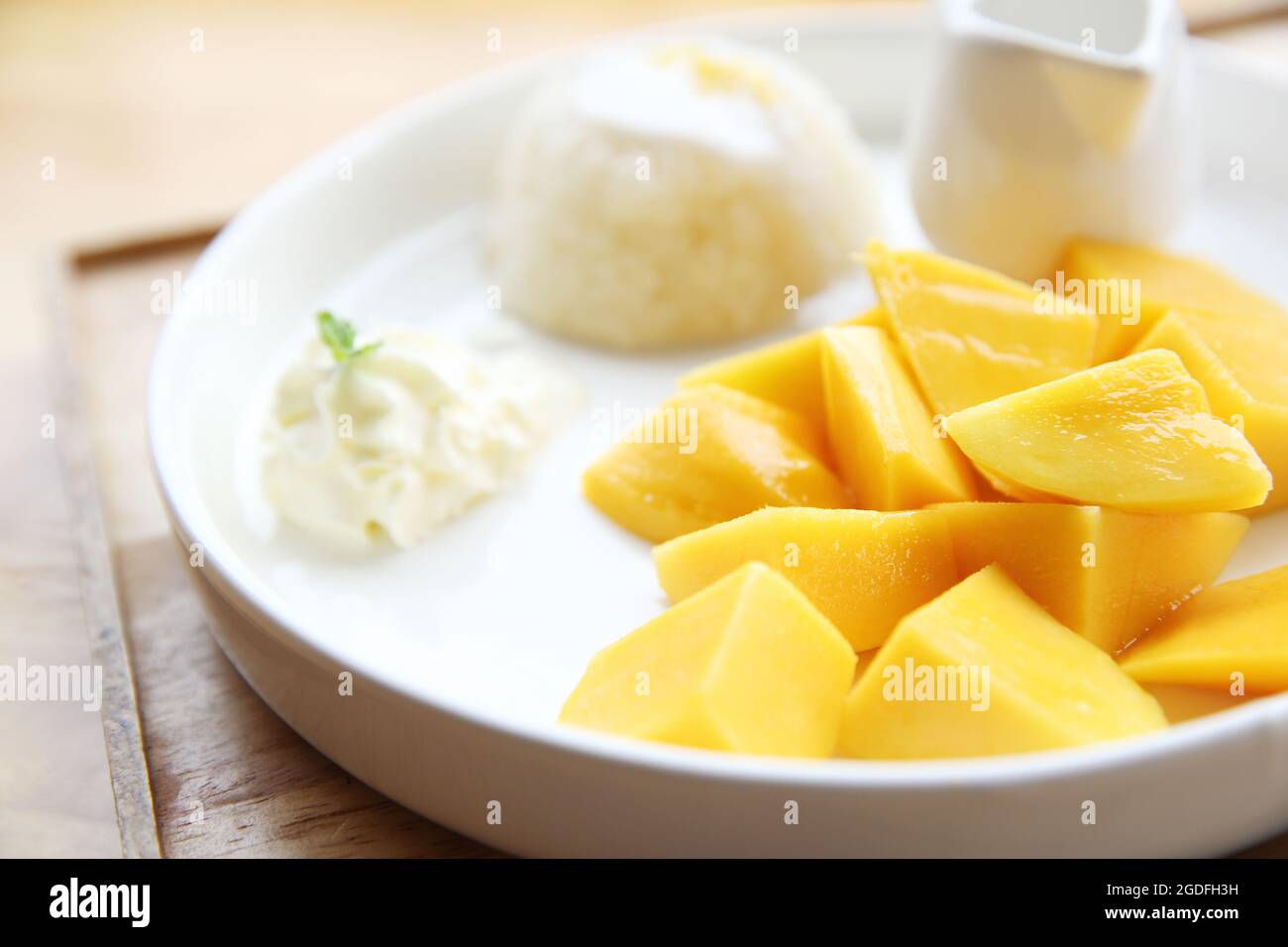 Sticky Rice with Mango on wood background Stock Photo - Alamy