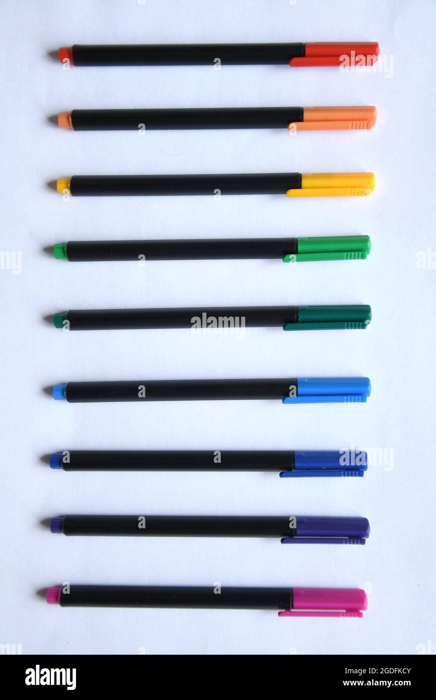 Overhead photo of colorful pens on white background Stock Photo - Alamy
