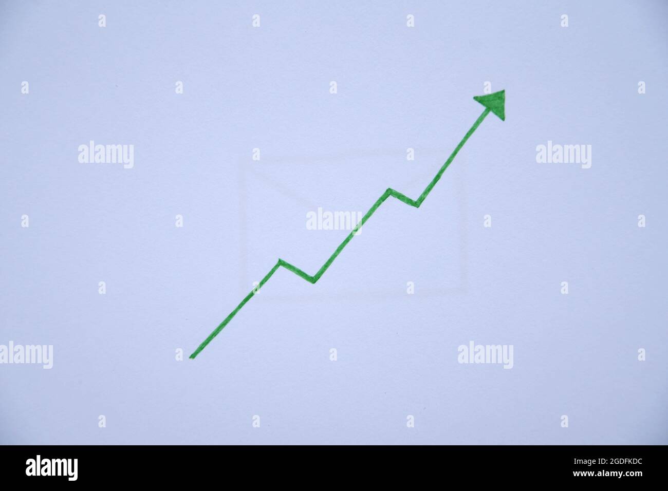 Photo of a green arrow pointing up on white paper, positive trend and ...
