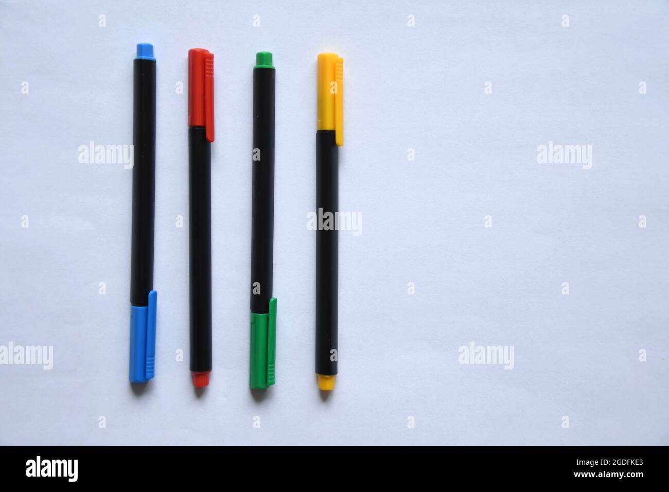 Overhead photo of colorful pens on white background Stock Photo - Alamy