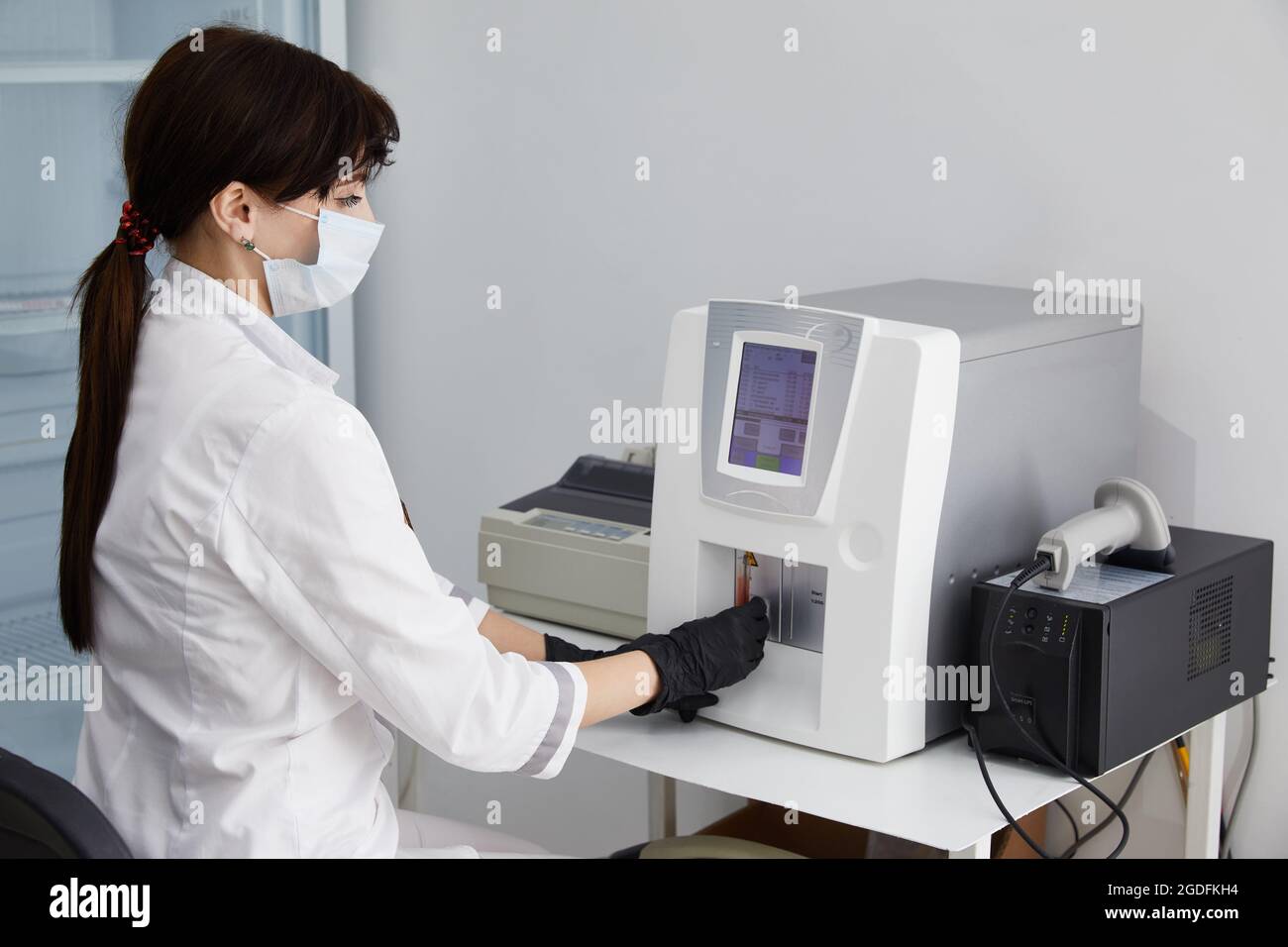 Female Research Scientist Putting Test Tube with Blood Sample into ...