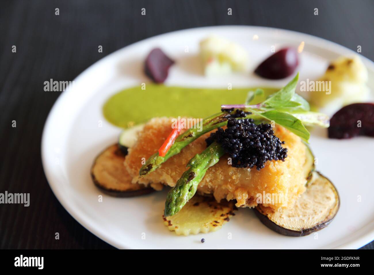 Fried fish fillet with green sauce Stock Photo - Alamy