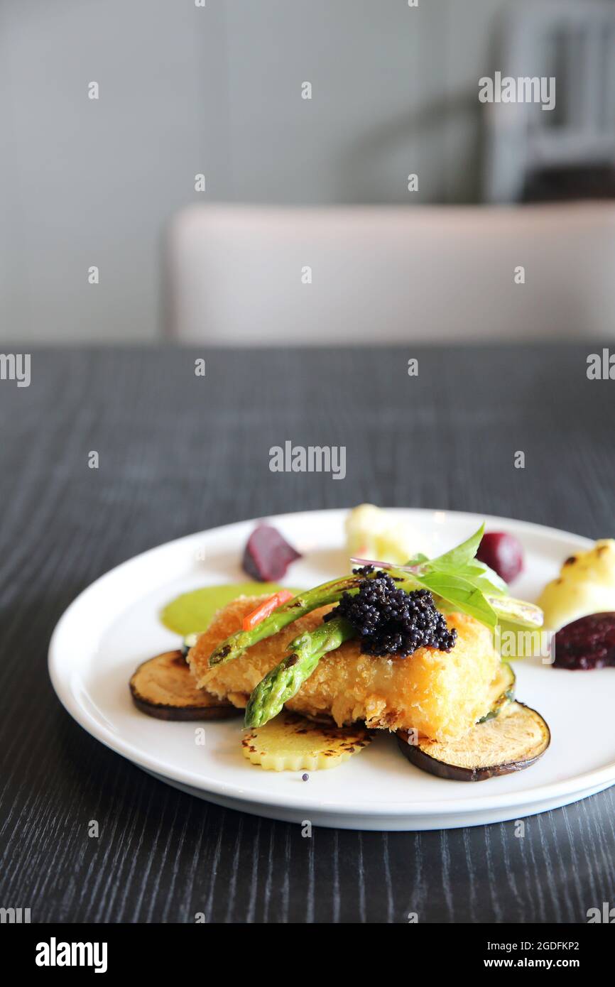 Fried fish fillet with green sauce Stock Photo - Alamy