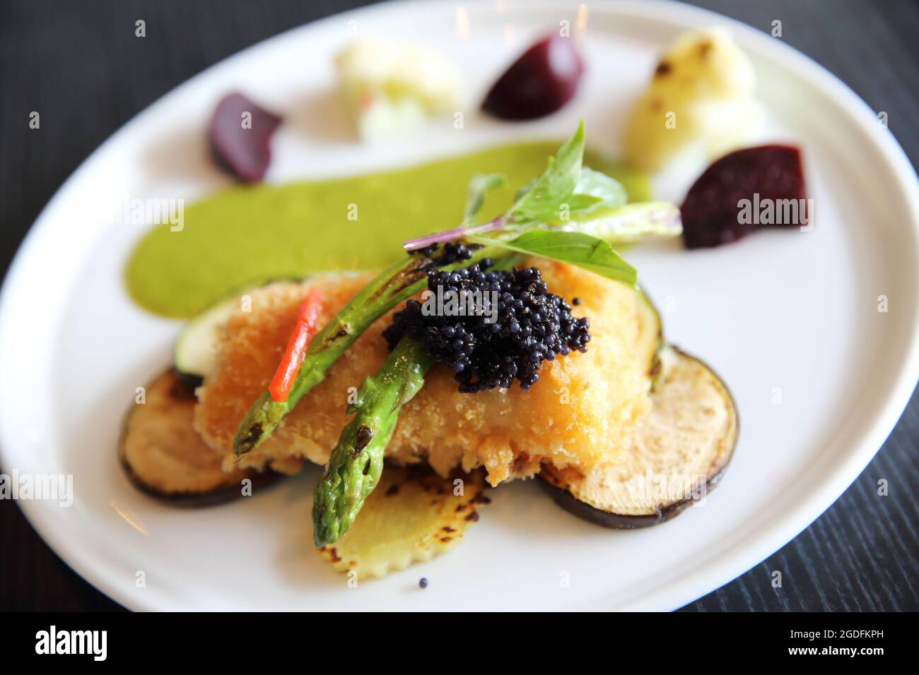 Fried fish fillet with green sauce Stock Photo - Alamy