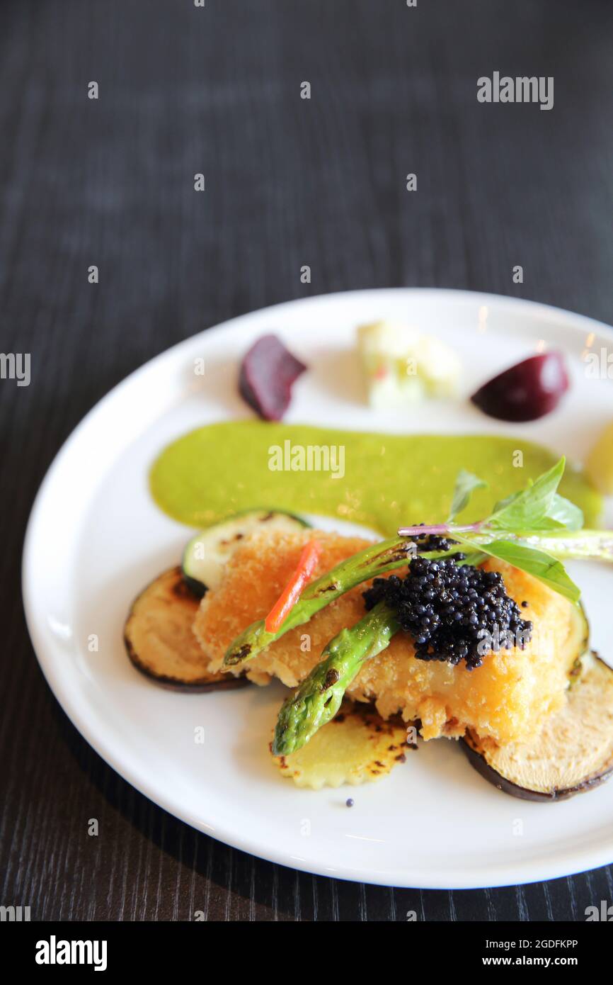Fried fish fillet with green sauce Stock Photo - Alamy
