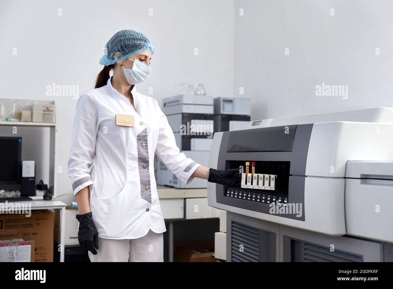 Female Research Scientist Putting Test Tube with Blood Sample into ...
