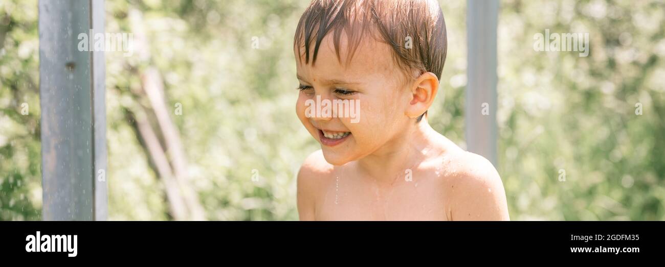 little contented wet four year old kid boy with water drops on his skin ...