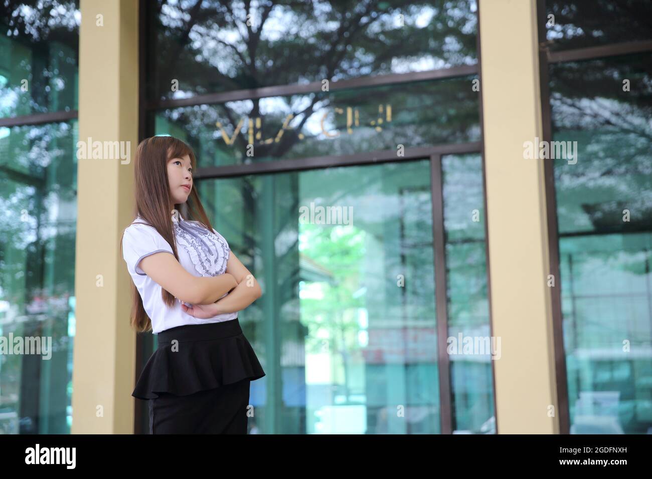 Young Asian business woman standing over office background Stock Photo ...