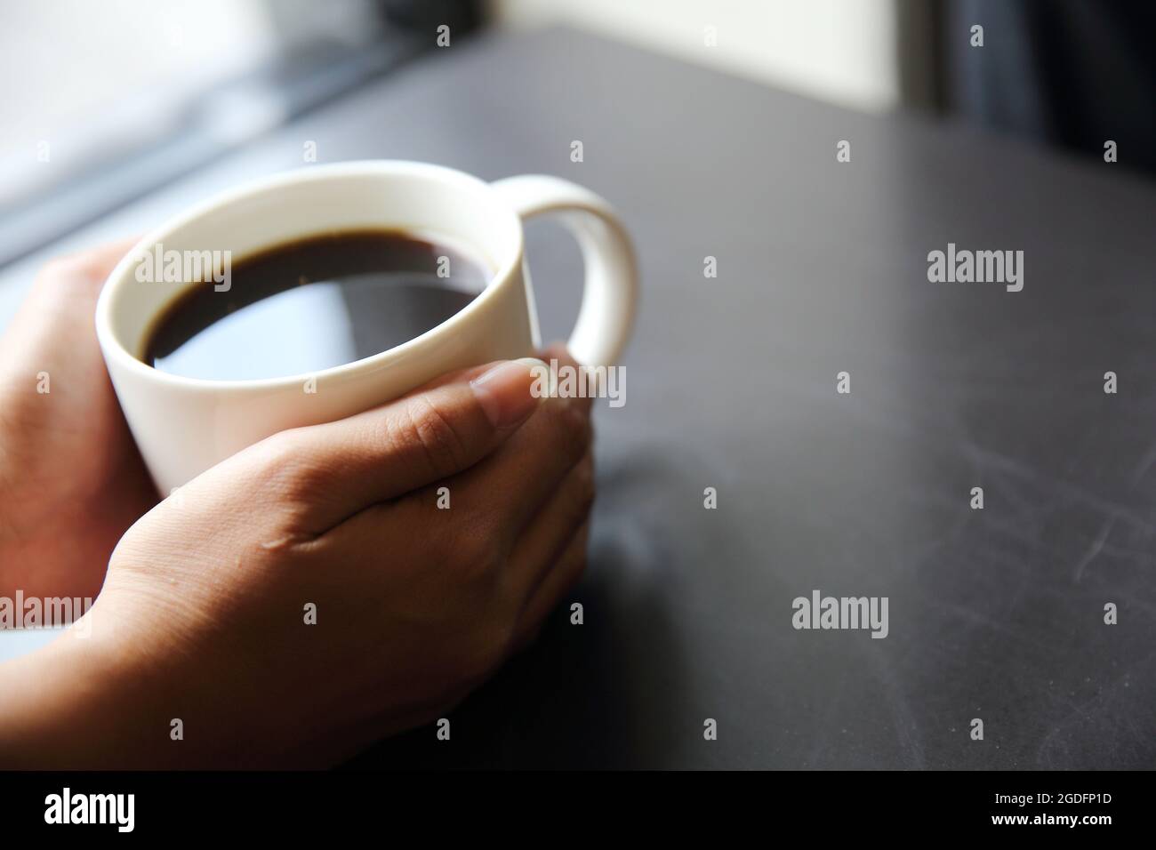 Black coffee with hand on wood background in coffee shop Stock Photo ...