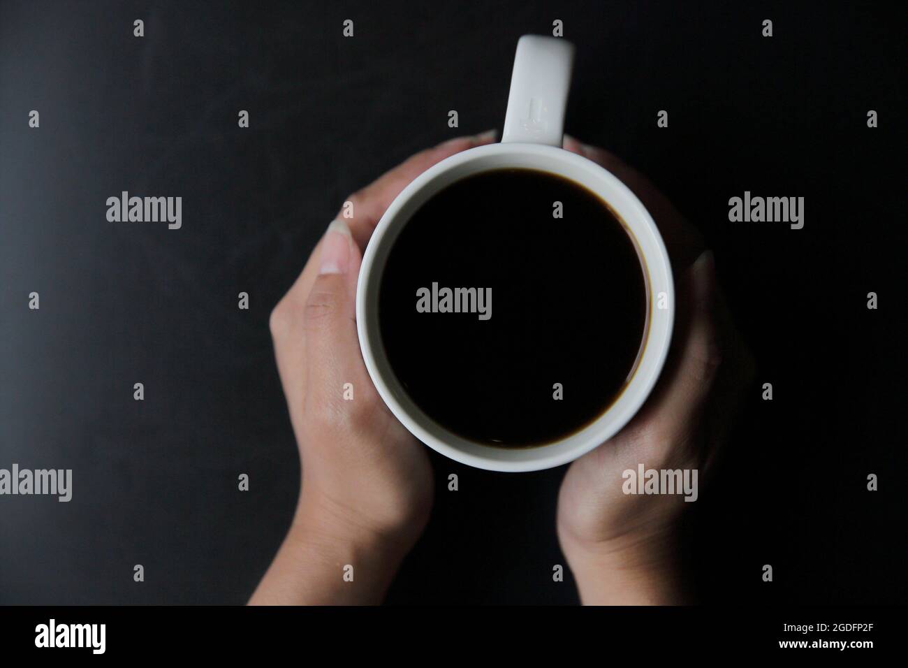 Black coffee with hand on wood background in coffee shop Stock Photo ...