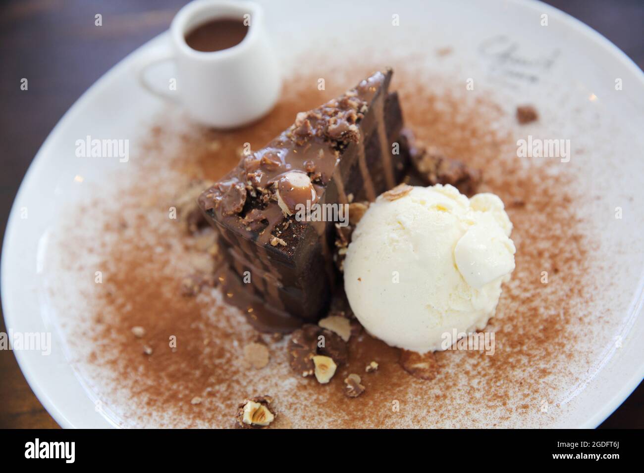 Dark chocolate cake with vanilla ice cream dessert Stock Photo - Alamy