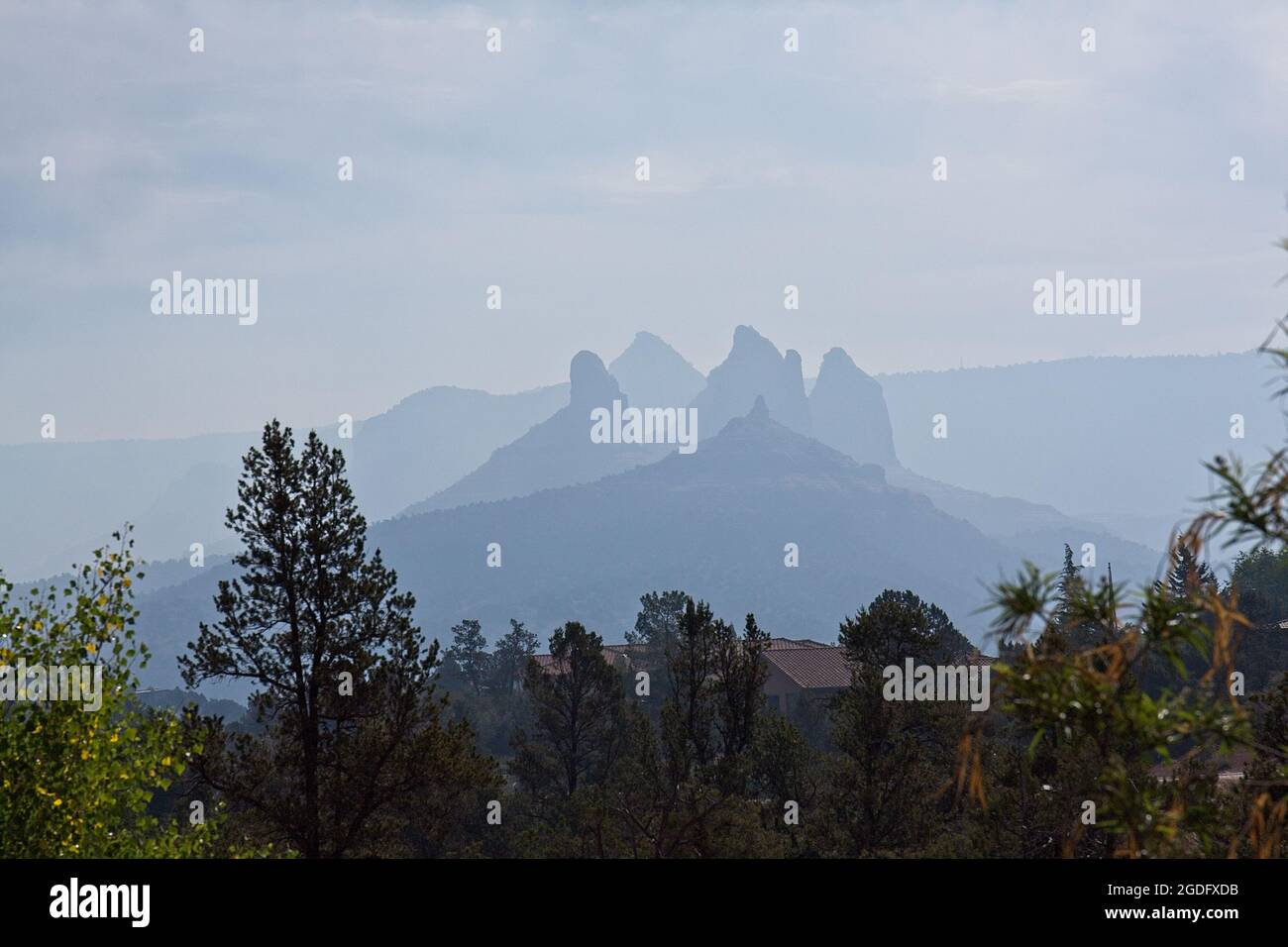 Fire in the distance in Oak Creek Canyon, Arizona during daylight Stock ...