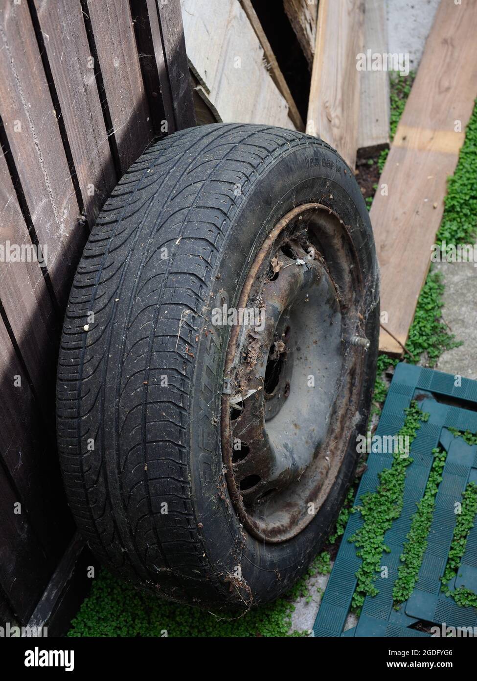 An old car wheel with partly worn tyre Stock Photo - Alamy