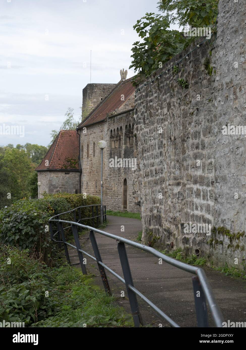Medieval caste wall near the bushes under the cloudy sky Stock Photo ...