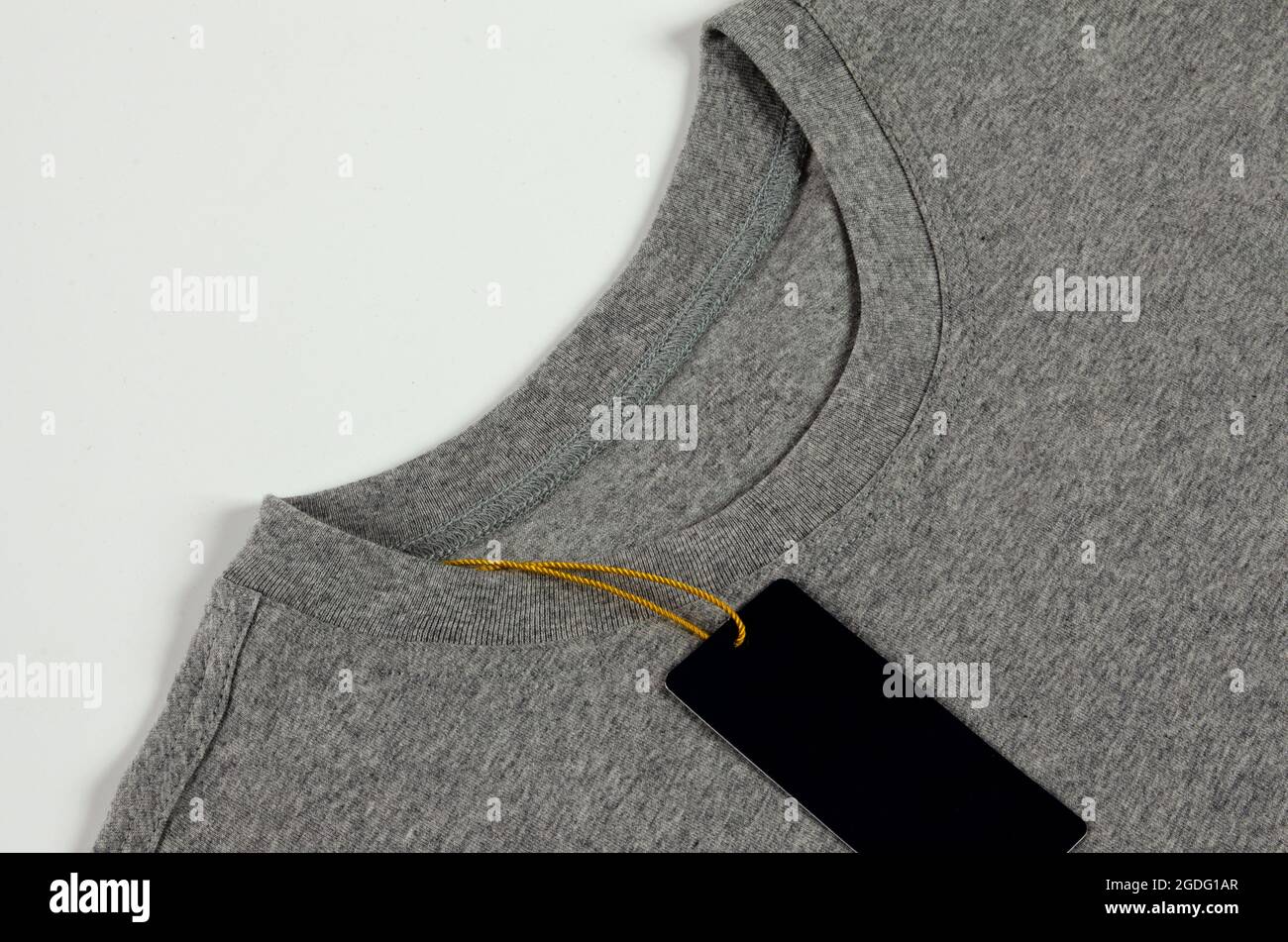 Plain gray T-shirt with a black empty tag Stock Photo - Alamy