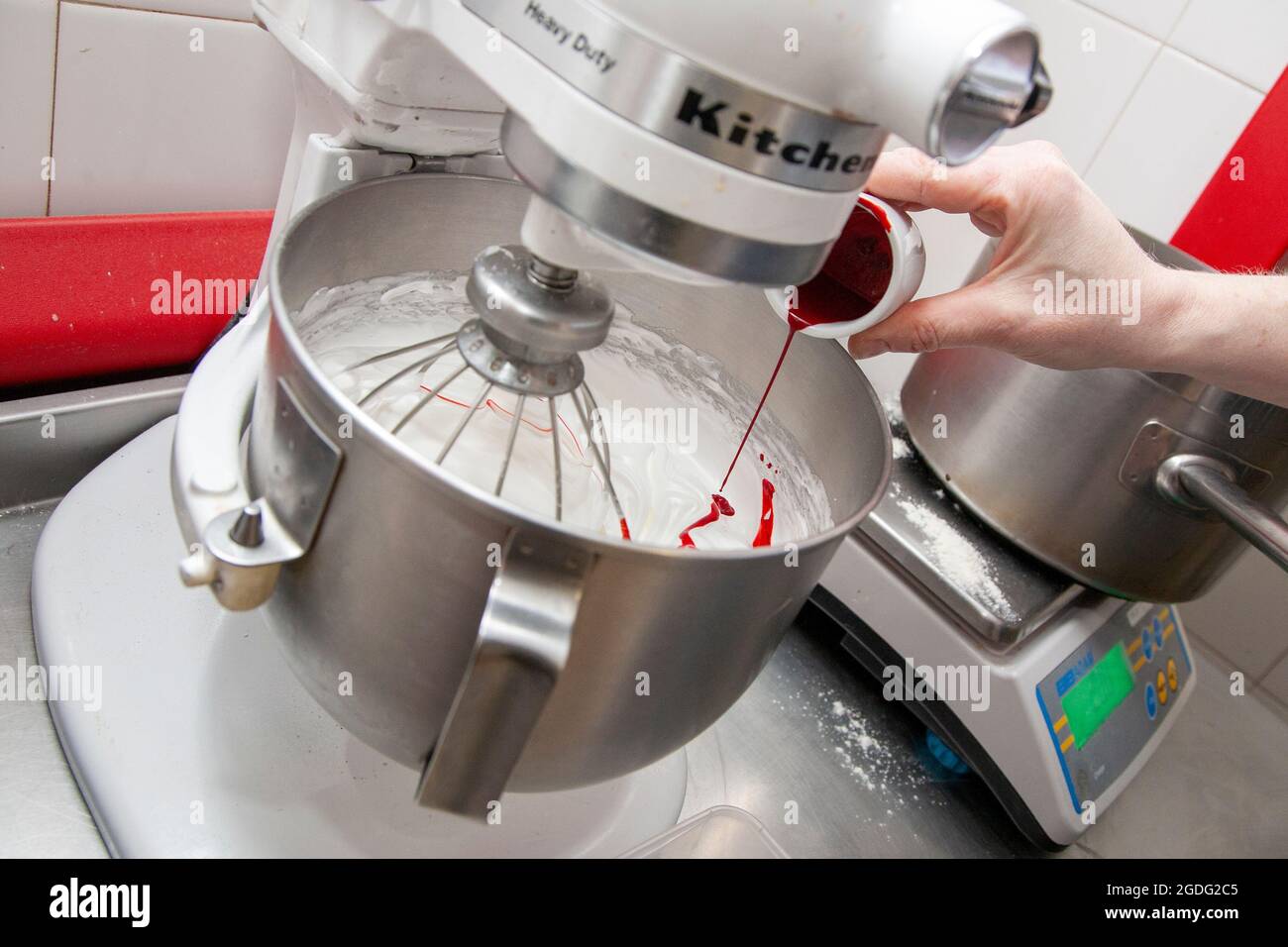 Adding food colouring to egg white to create the base for macarons ...