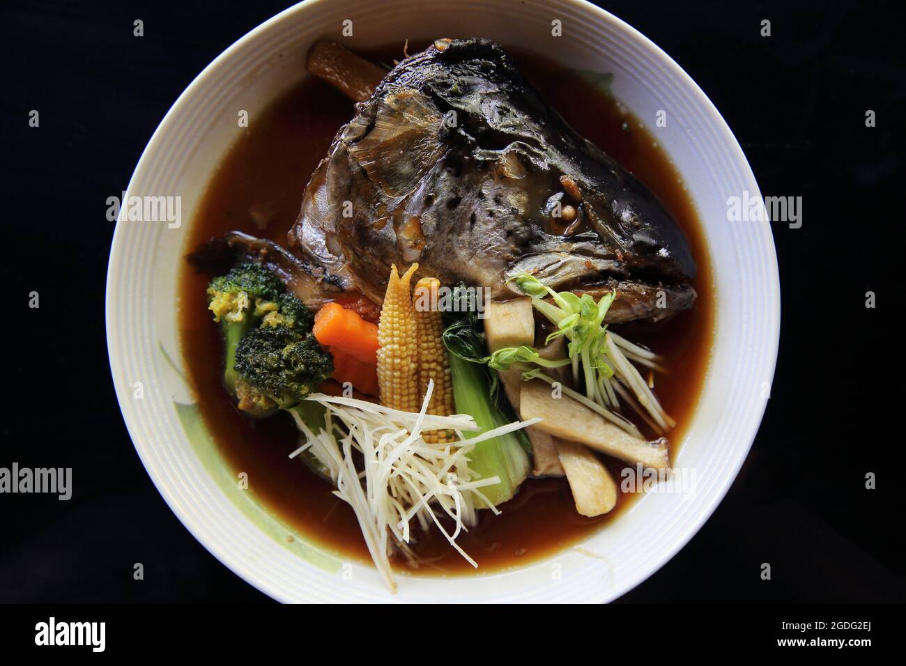 Japanese food bolied head fish with sauce Stock Photo - Alamy