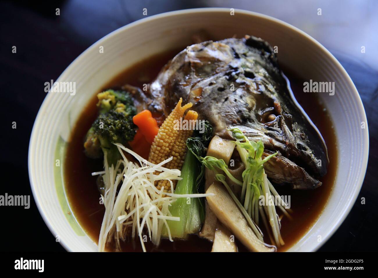 Japanese food bolied head fish with sauce Stock Photo - Alamy