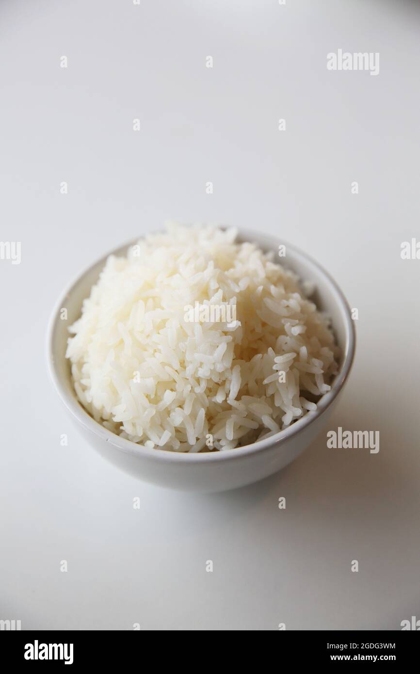 Cooked rice in bowl isolated in white background Stock Photo - Alamy